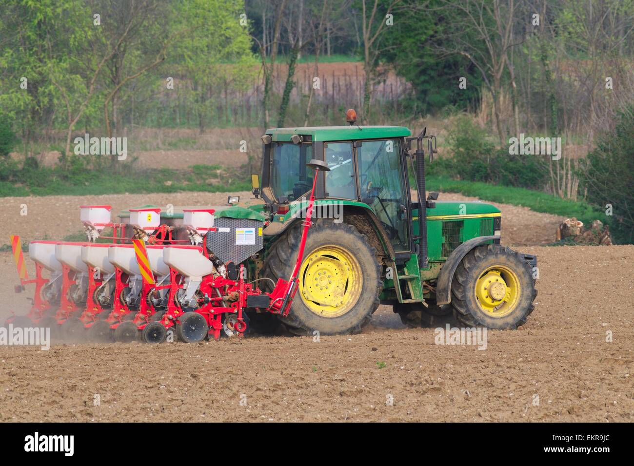Farm tractor with seeder working in a field Stock Photo - Alamy