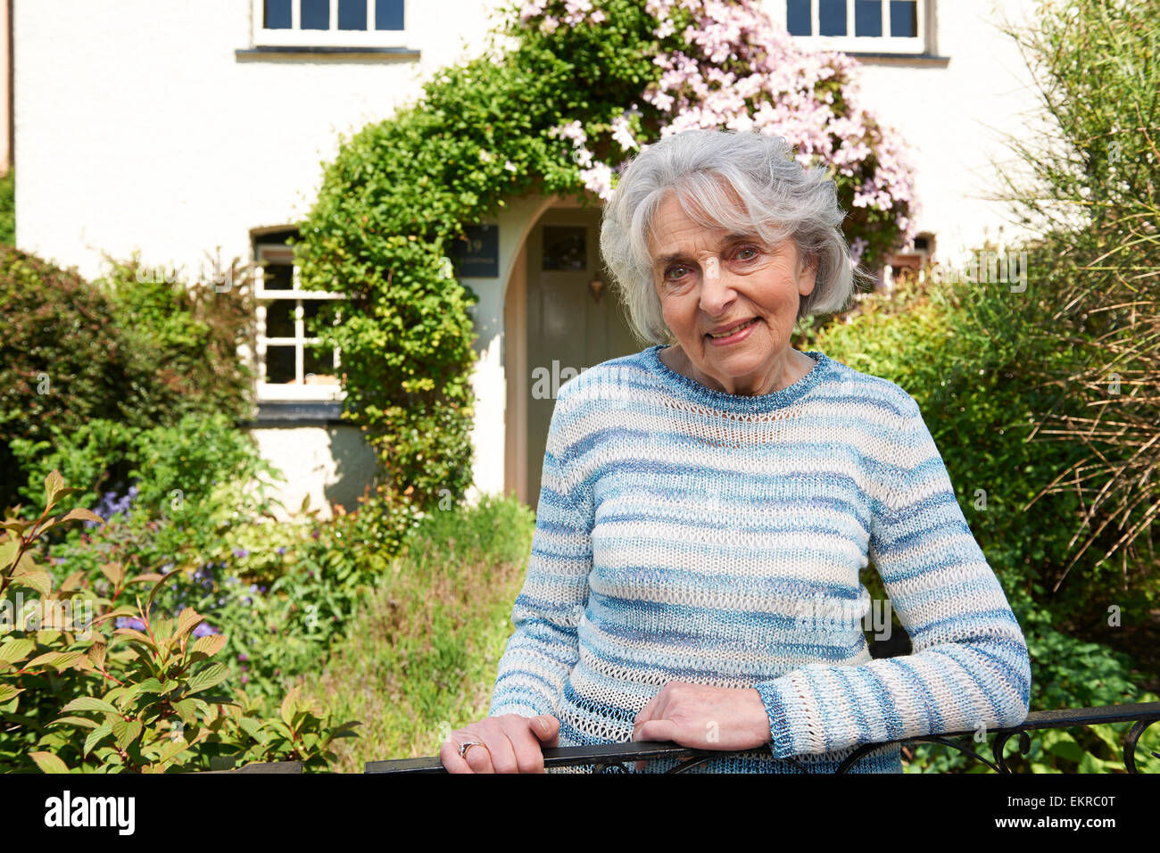 Senior Woman Standing Outside Pretty Cottage Stock Photo - Alamy