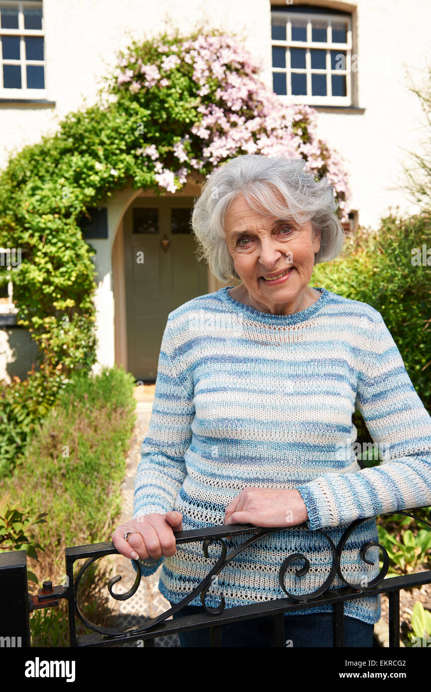 Senior Woman Standing Outside Pretty Cottage Stock Photo - Alamy