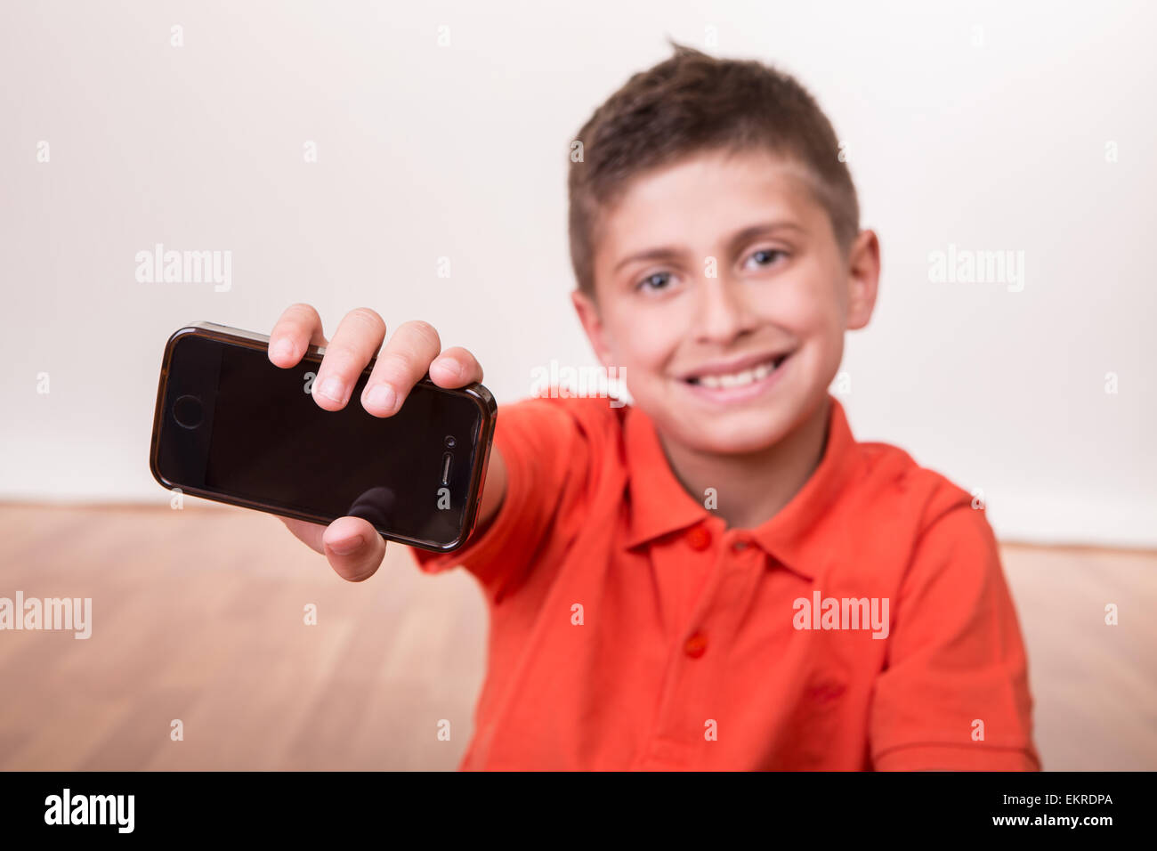 Blond cute boy holding his own cellphone Stock Photo - Alamy