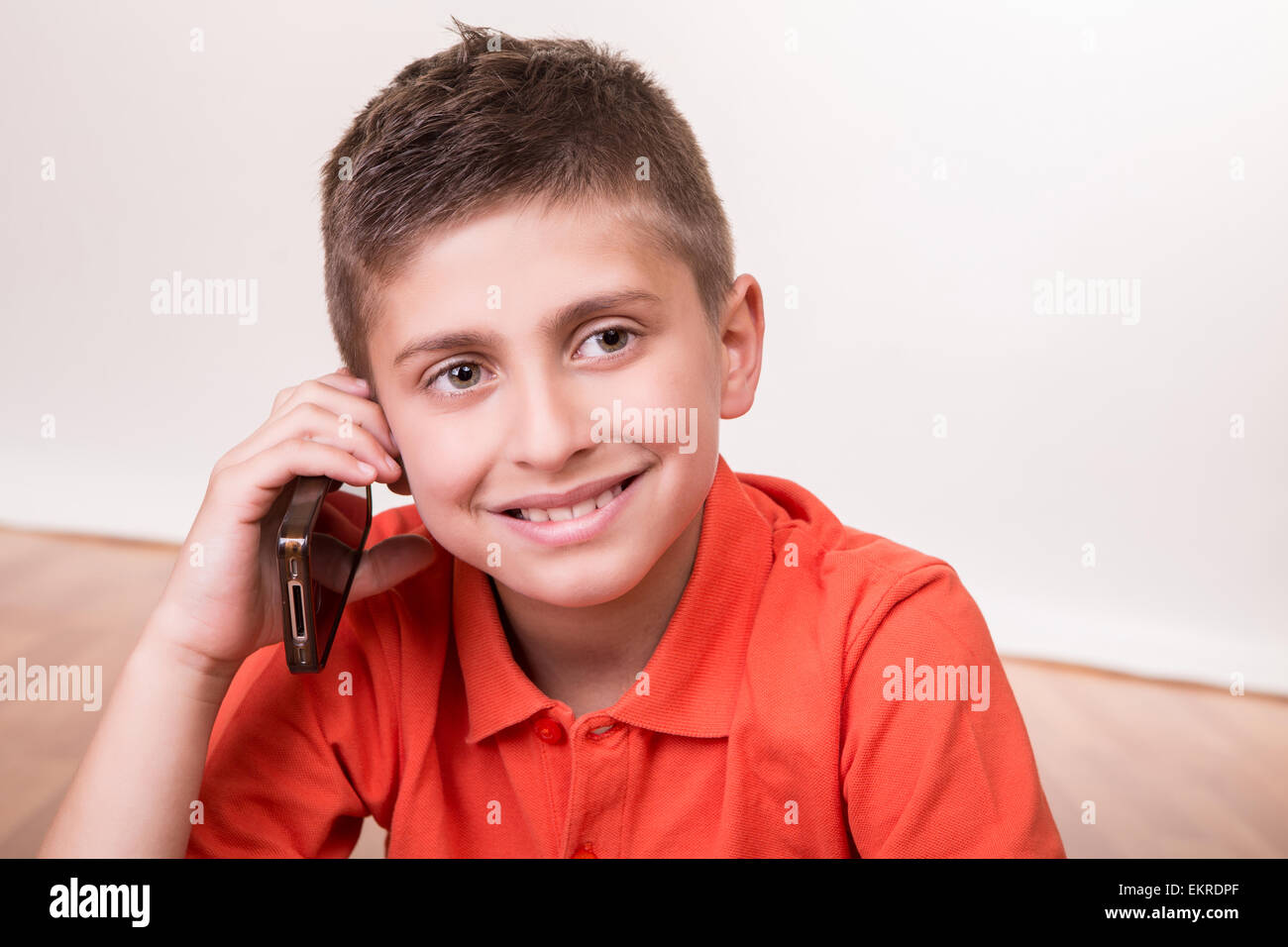 Blond cute boy calling from his cellphone Stock Photo - Alamy