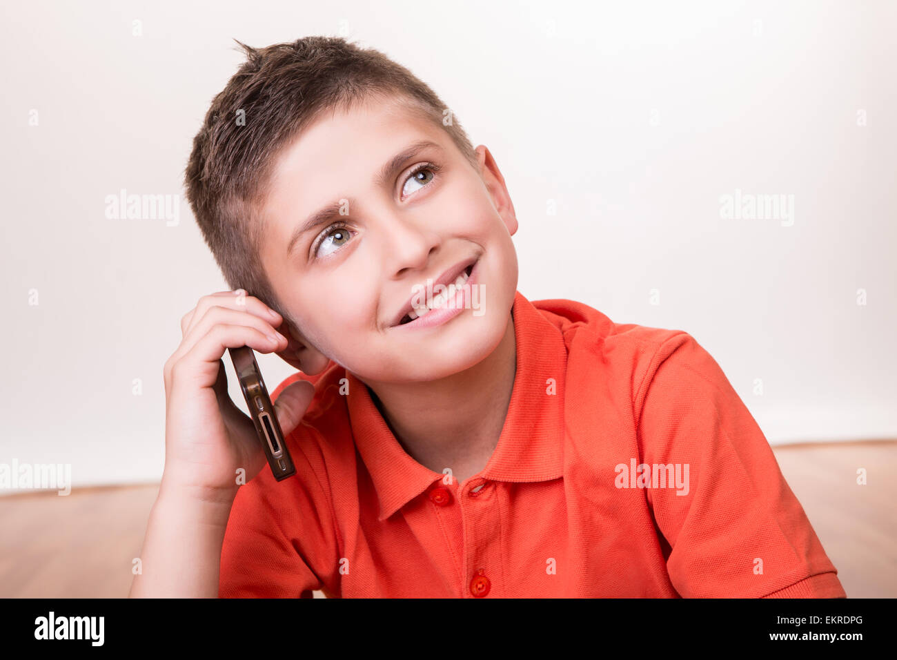 Blond cute boy calling from his cellphone Stock Photo - Alamy