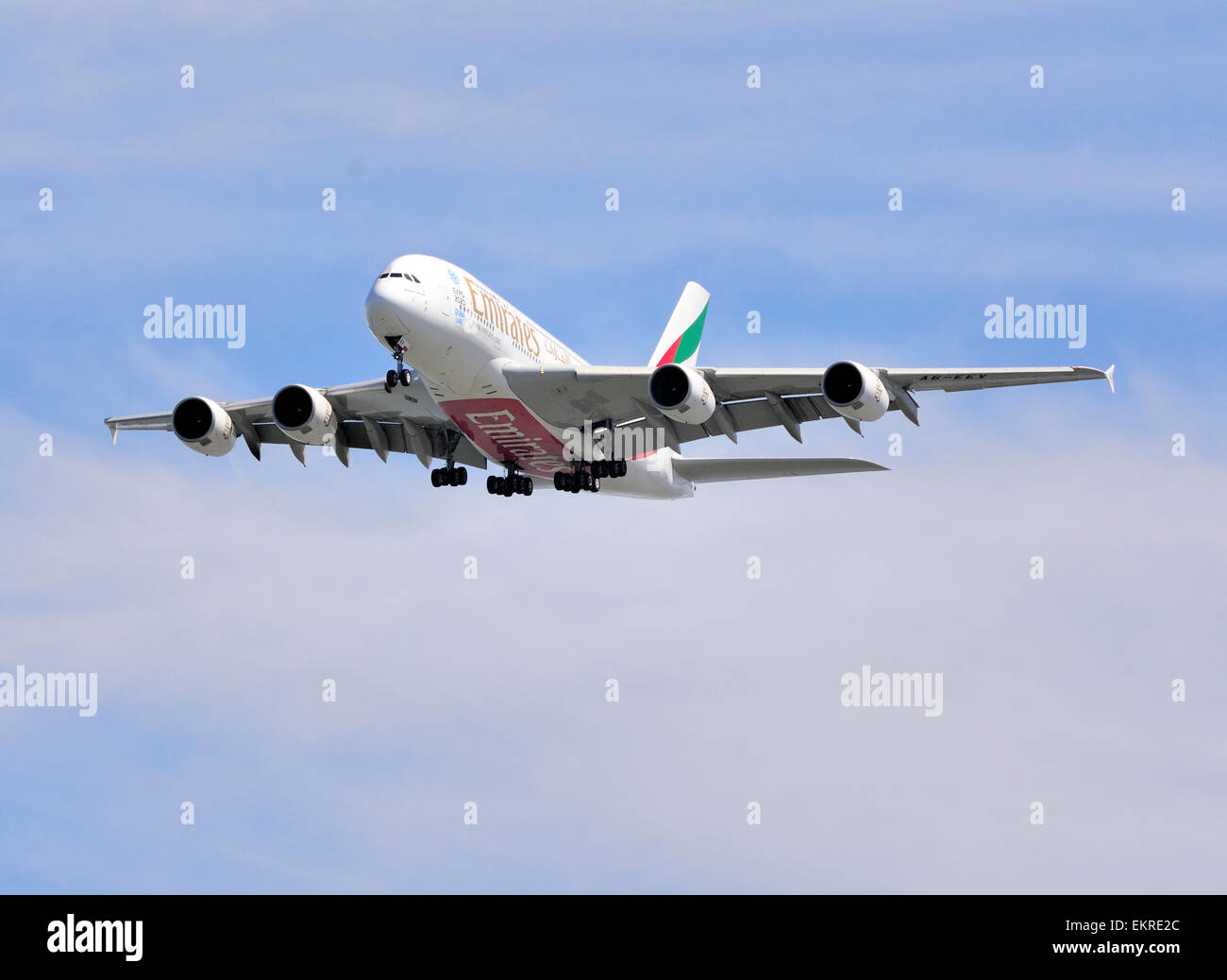 An Emirates Airbus A380 climbs through a light blue sky, featuring its ...