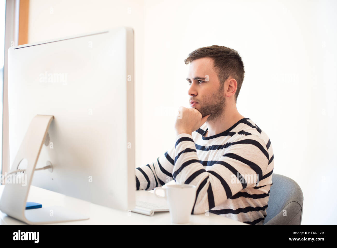Handsome young man working at the office Stock Photo - Alamy