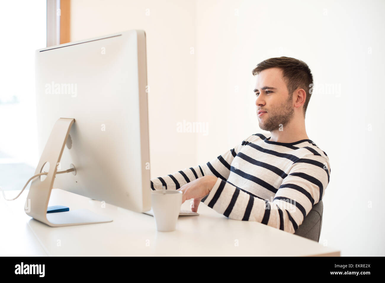 Handsome young man working at the office Stock Photo - Alamy