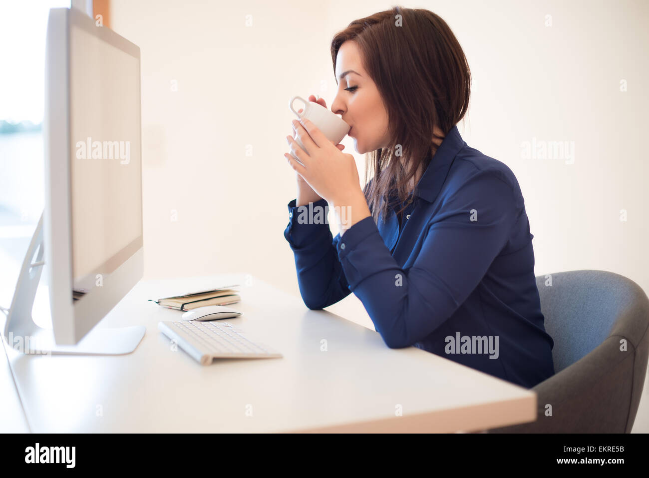 Woman working with computer on her desk Stock Photo - Alamy