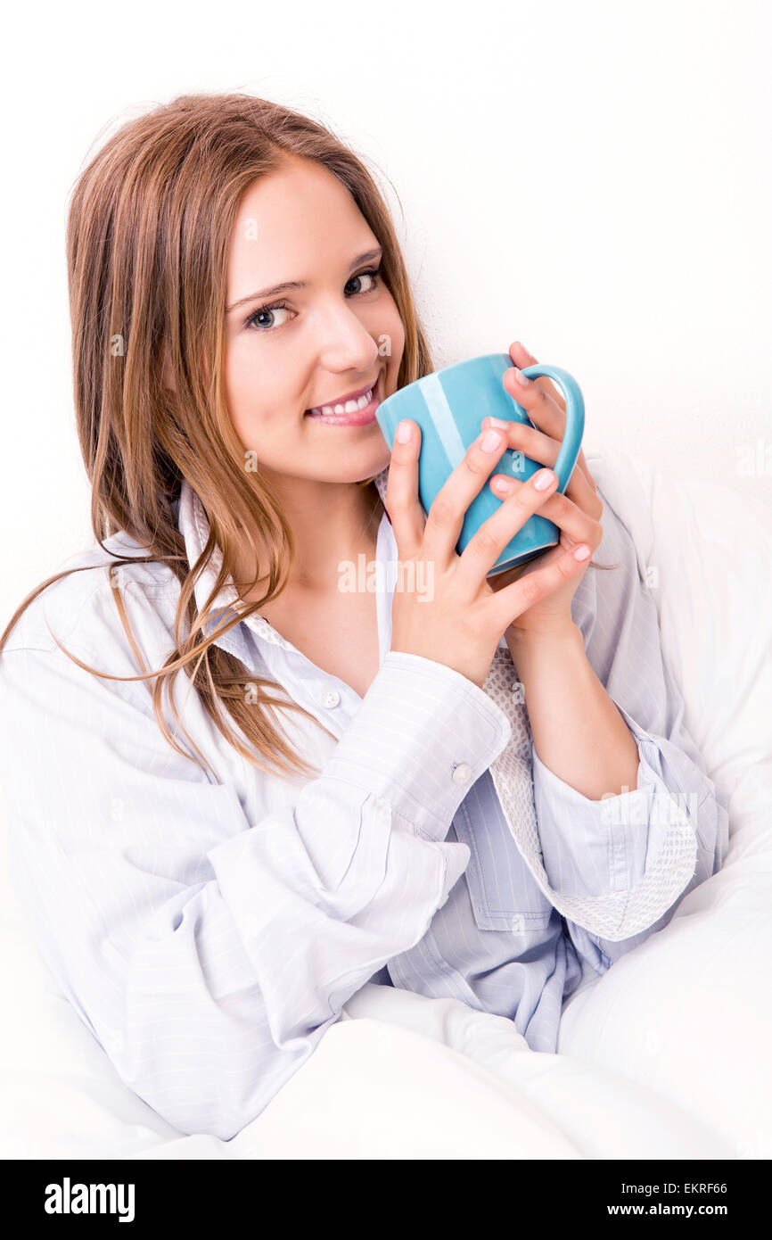 Young beautiful woman drinking something in bed Stock Photo - Alamy
