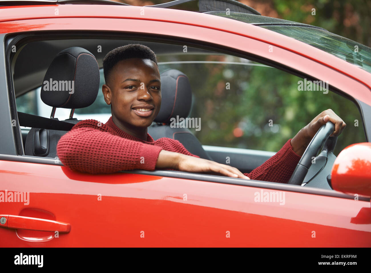 Male Teenage Driver Looking Out Of Car Window Stock Photo - Alamy