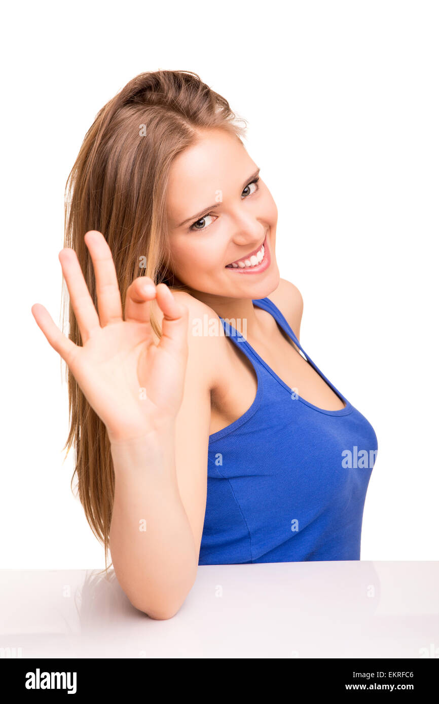 Portrait of a smiling woman showing OK sign over white background Stock ...