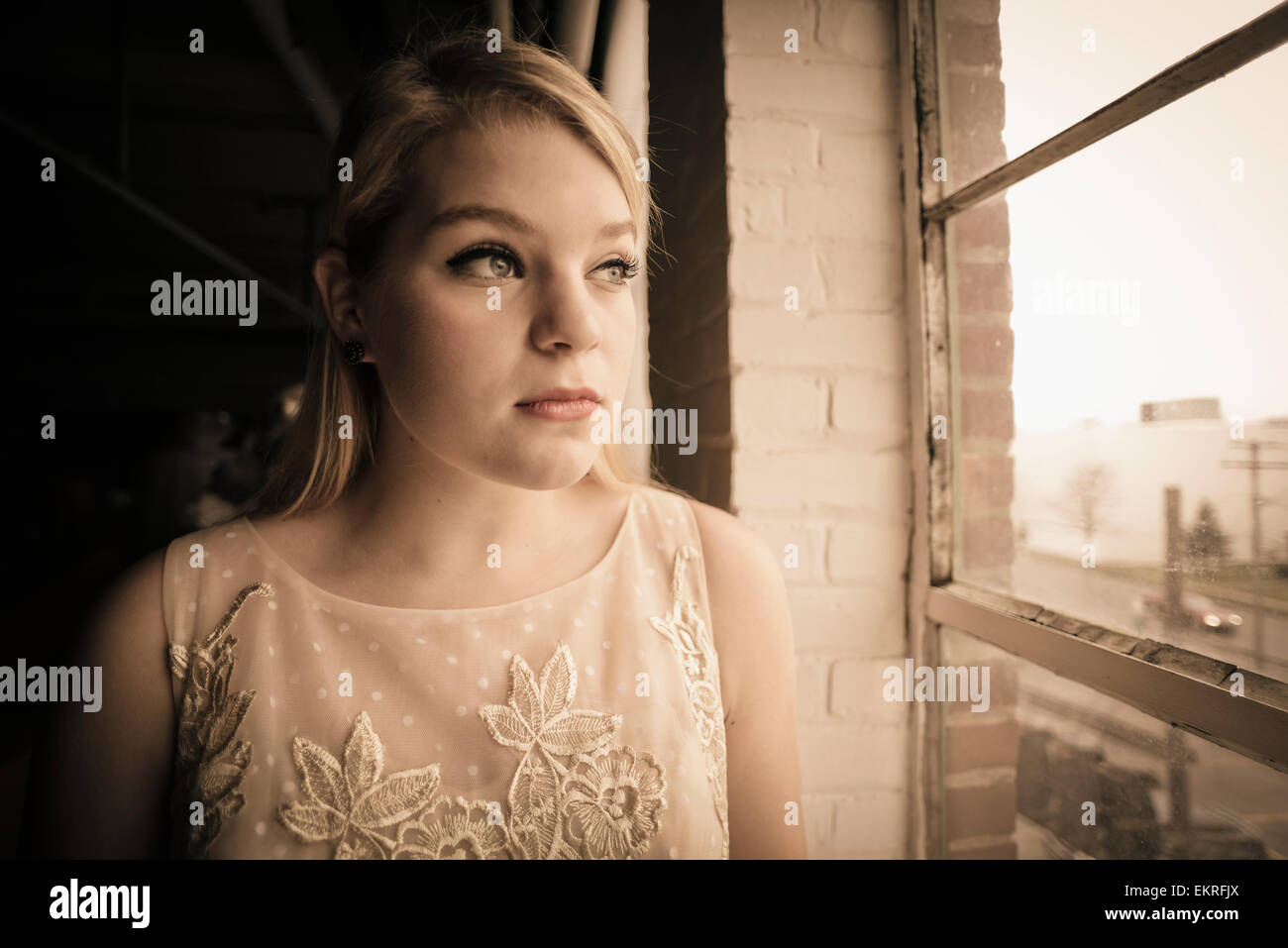 A young woman watches out the window; New York, United States of ...