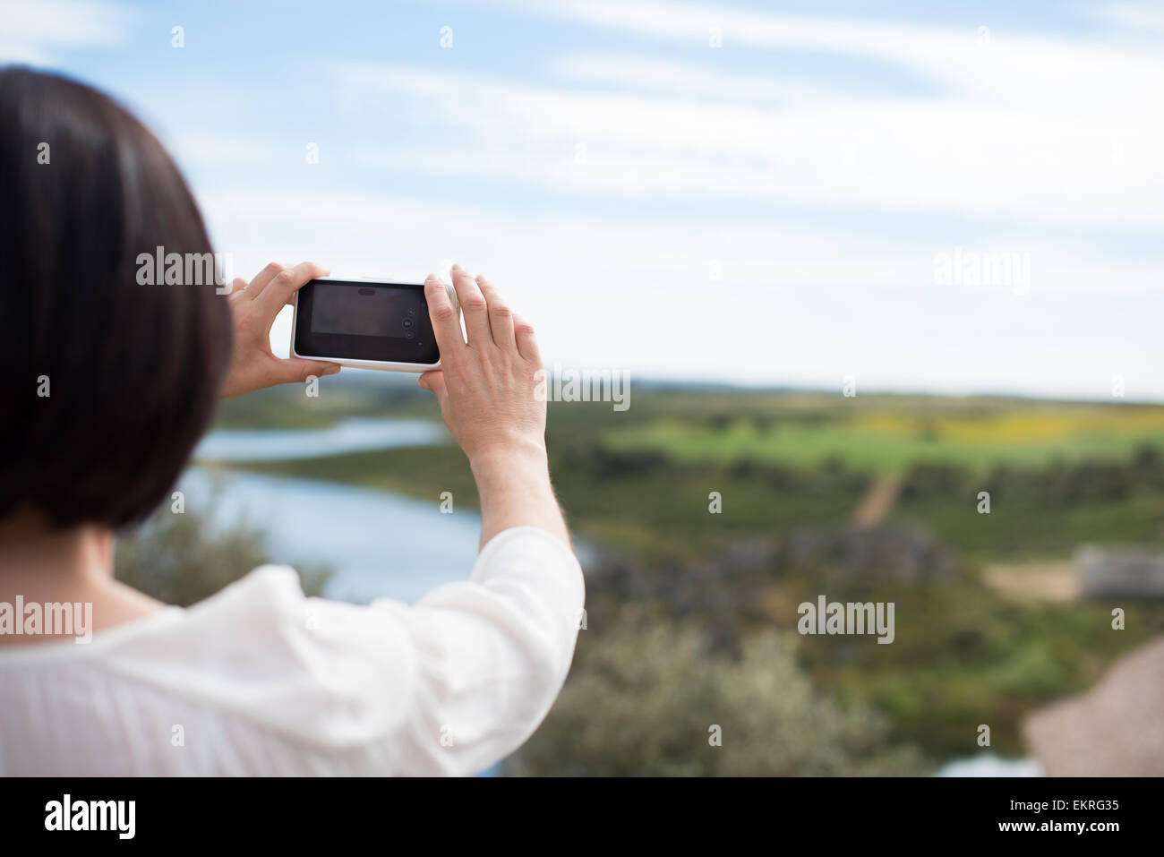 Back view of a woman taking photograph with a smart phone camera Stock ...