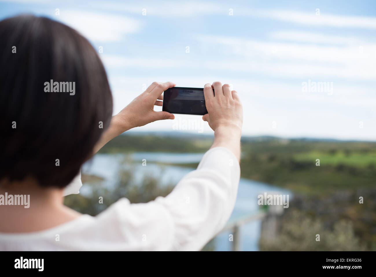 Back view of a woman taking photograph with a smart phone camera Stock ...