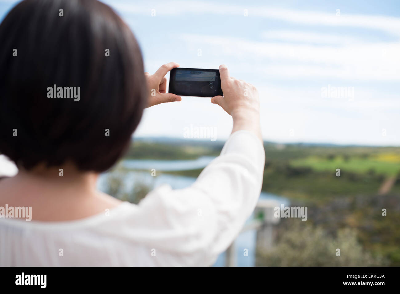 Back view of a woman taking photograph with a smart phone camera Stock ...