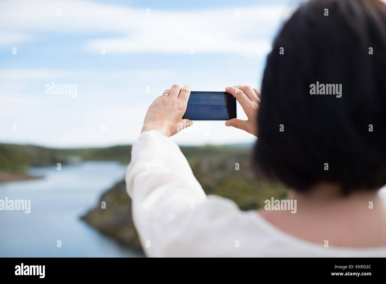 Back view of a woman taking photograph with a smart phone camera Stock ...