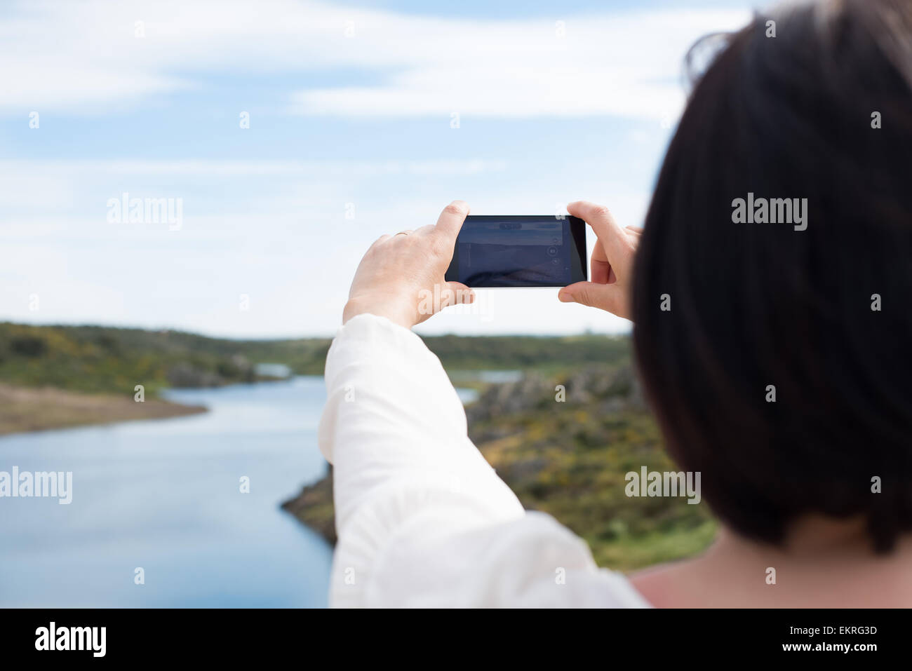 Back view of a woman taking photograph with a smart phone camera Stock ...