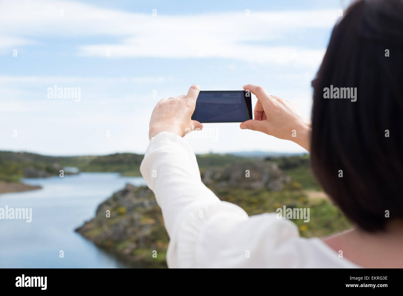 Back view of a woman taking photograph with a smart phone camera Stock ...