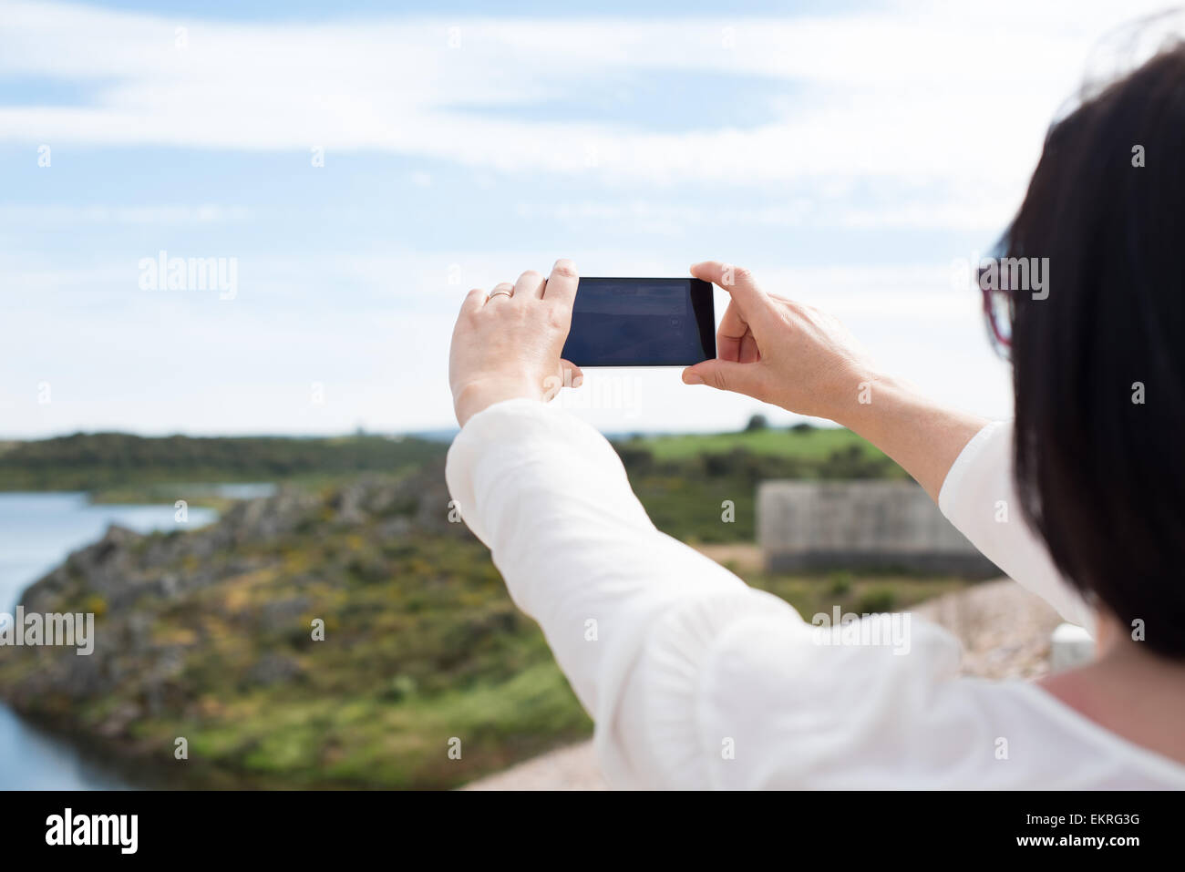 Back view of a woman taking photograph with a smart phone camera Stock ...