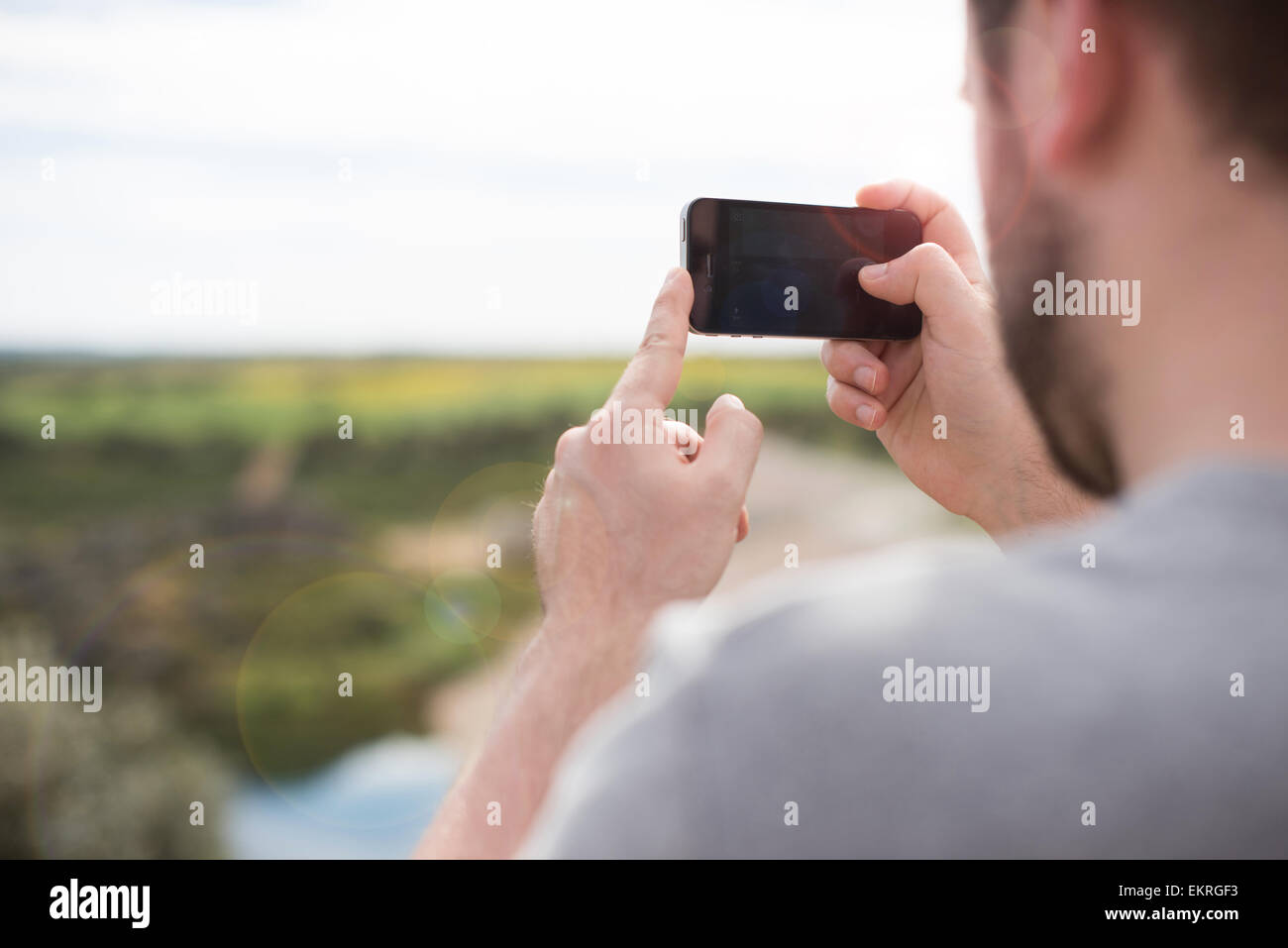 Back view of a mann taking photograph with a smart phone camera Stock ...