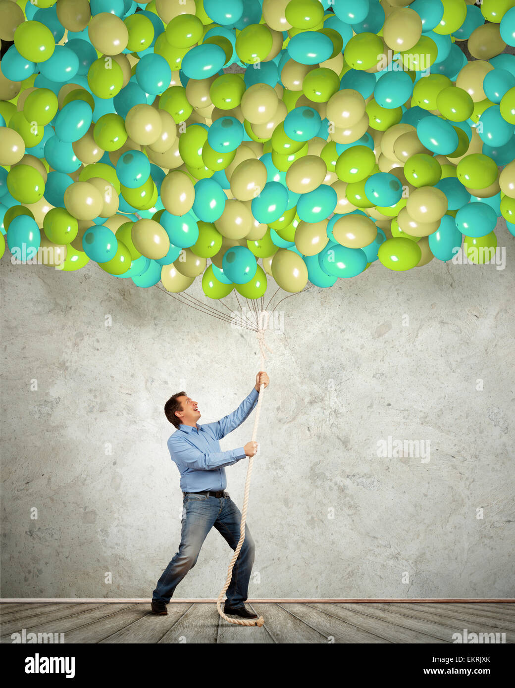 Adult man pulling a rope with balloons Stock Photo - Alamy