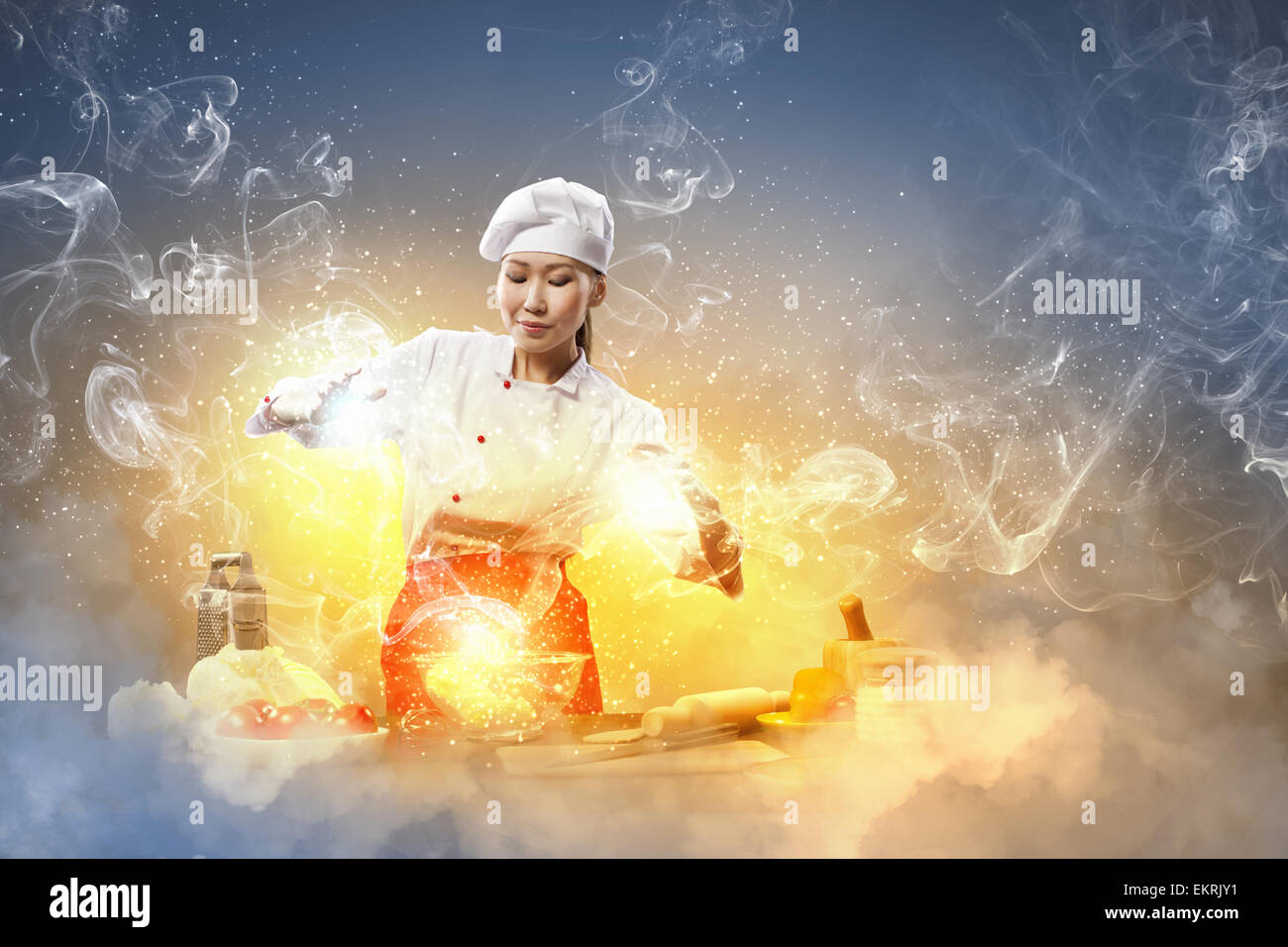 Asian female cooking with magic Stock Photo - Alamy
