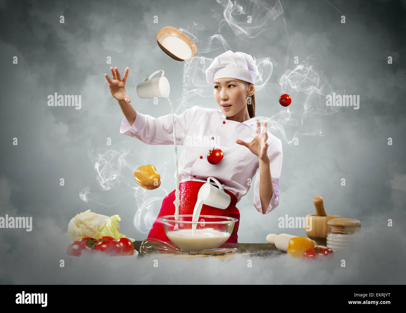 Asian female cooking with magic Stock Photo - Alamy
