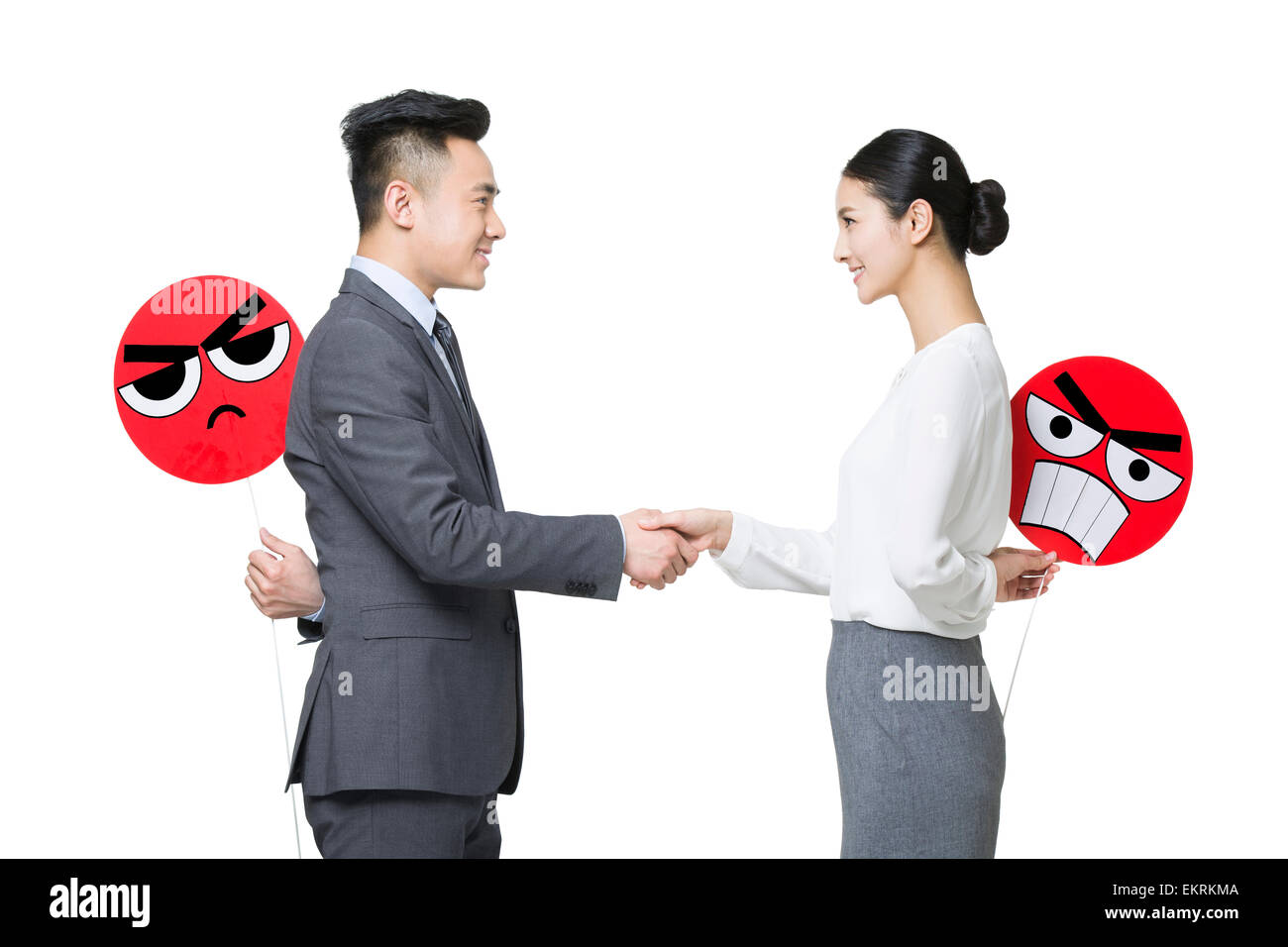 Business person shaking hands with angry emoticon faces behind their ...