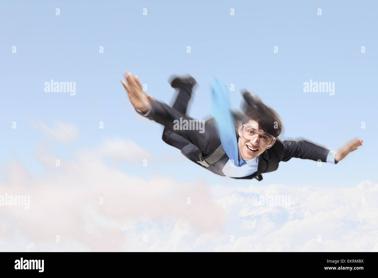 Young businessman flying with parachute on back Stock Photo - Alamy