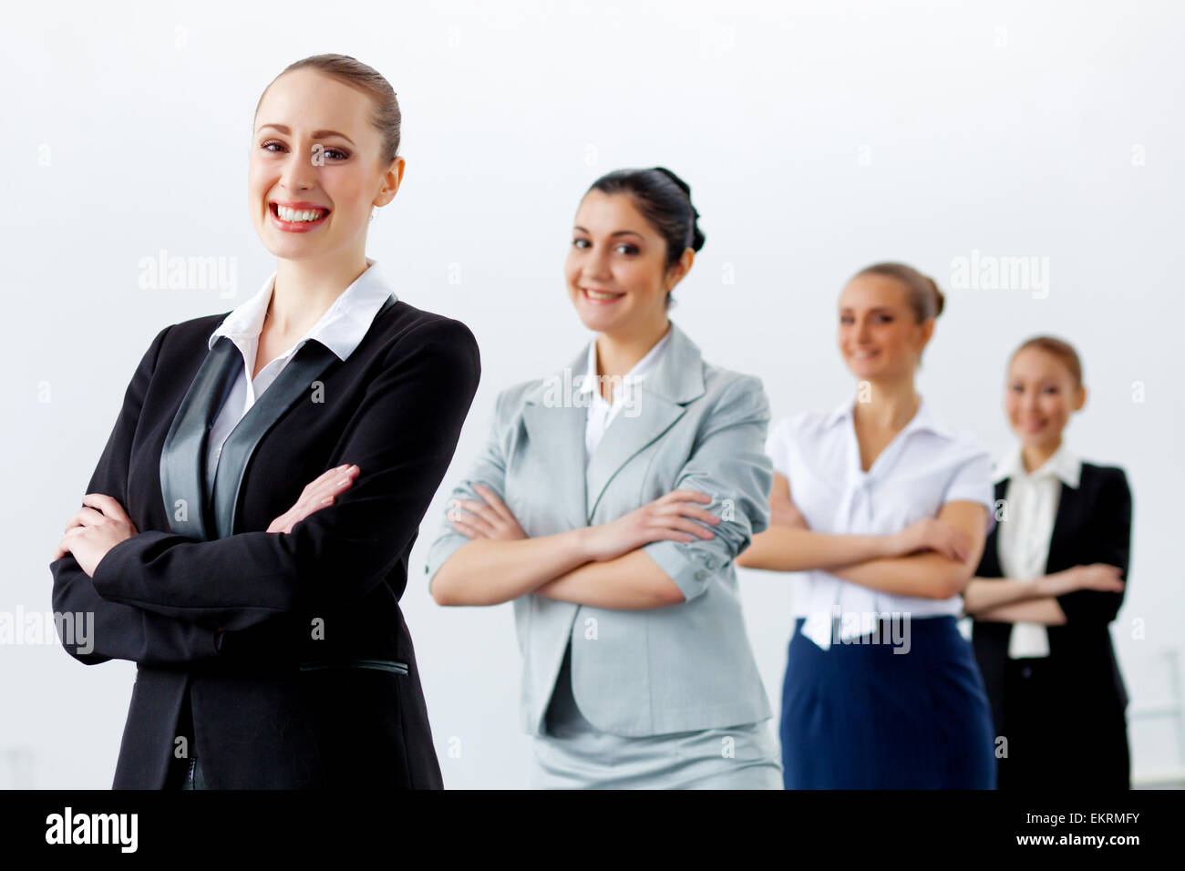 Four businesswomen standing in row Stock Photo - Alamy