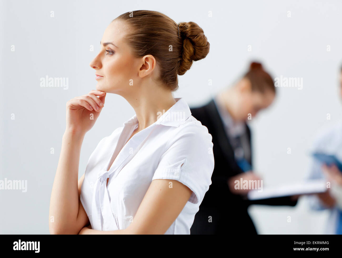 Attractive business woman thinking Stock Photo - Alamy