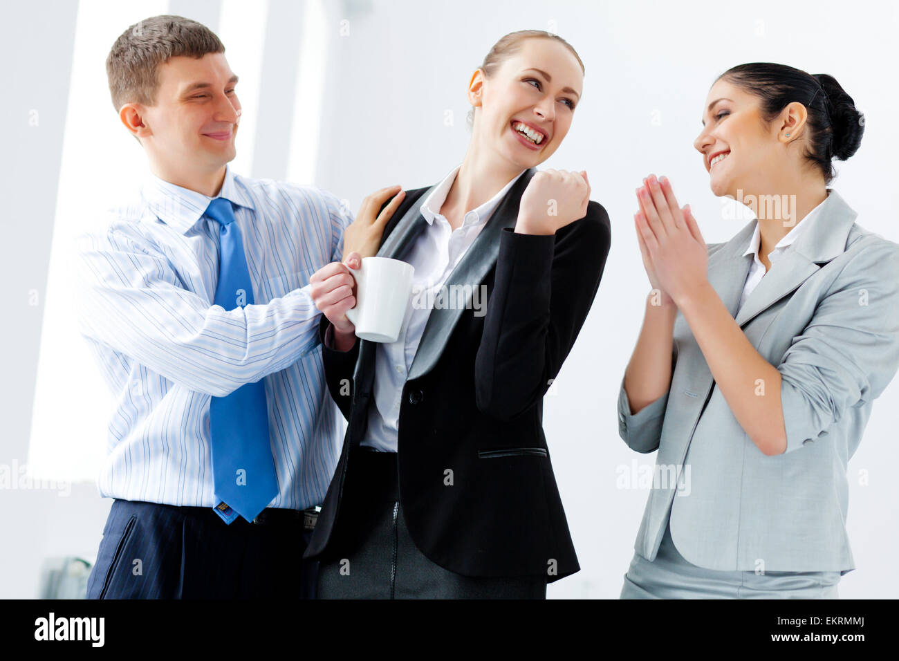 Three young business people laughing Stock Photo - Alamy