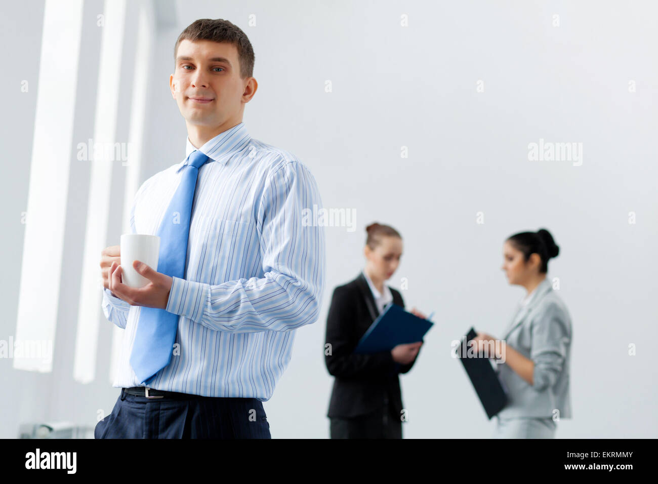 Three young business people laughing Stock Photo - Alamy