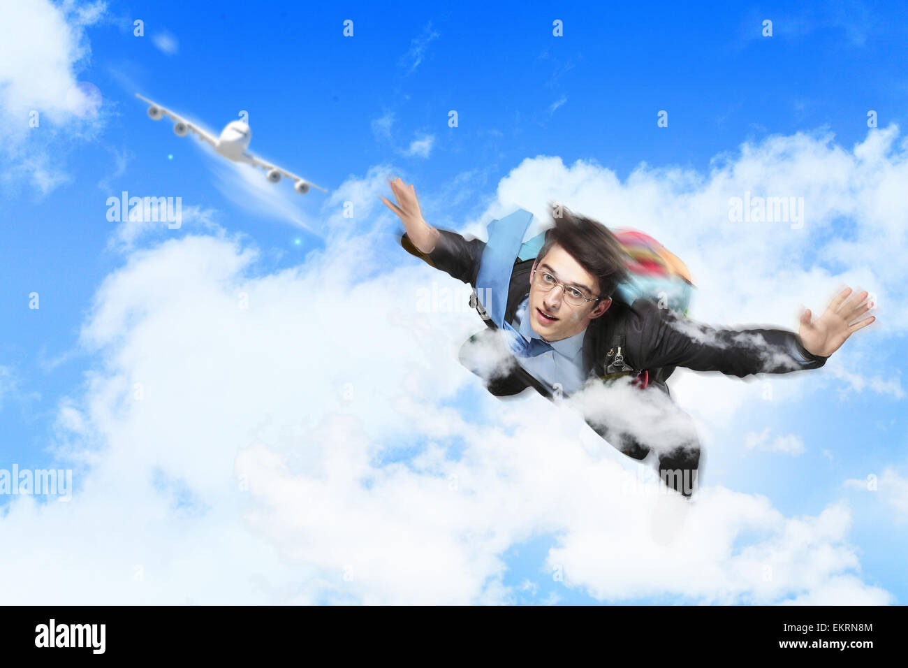 Young businessman flying with parachute on back Stock Photo - Alamy