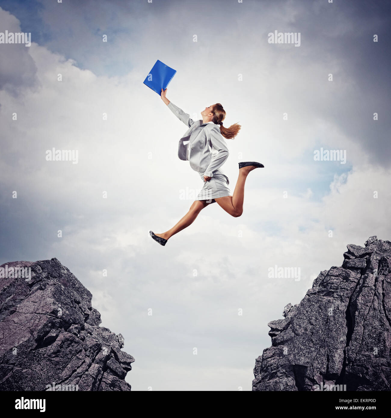Young businesswoman jumping Stock Photo - Alamy