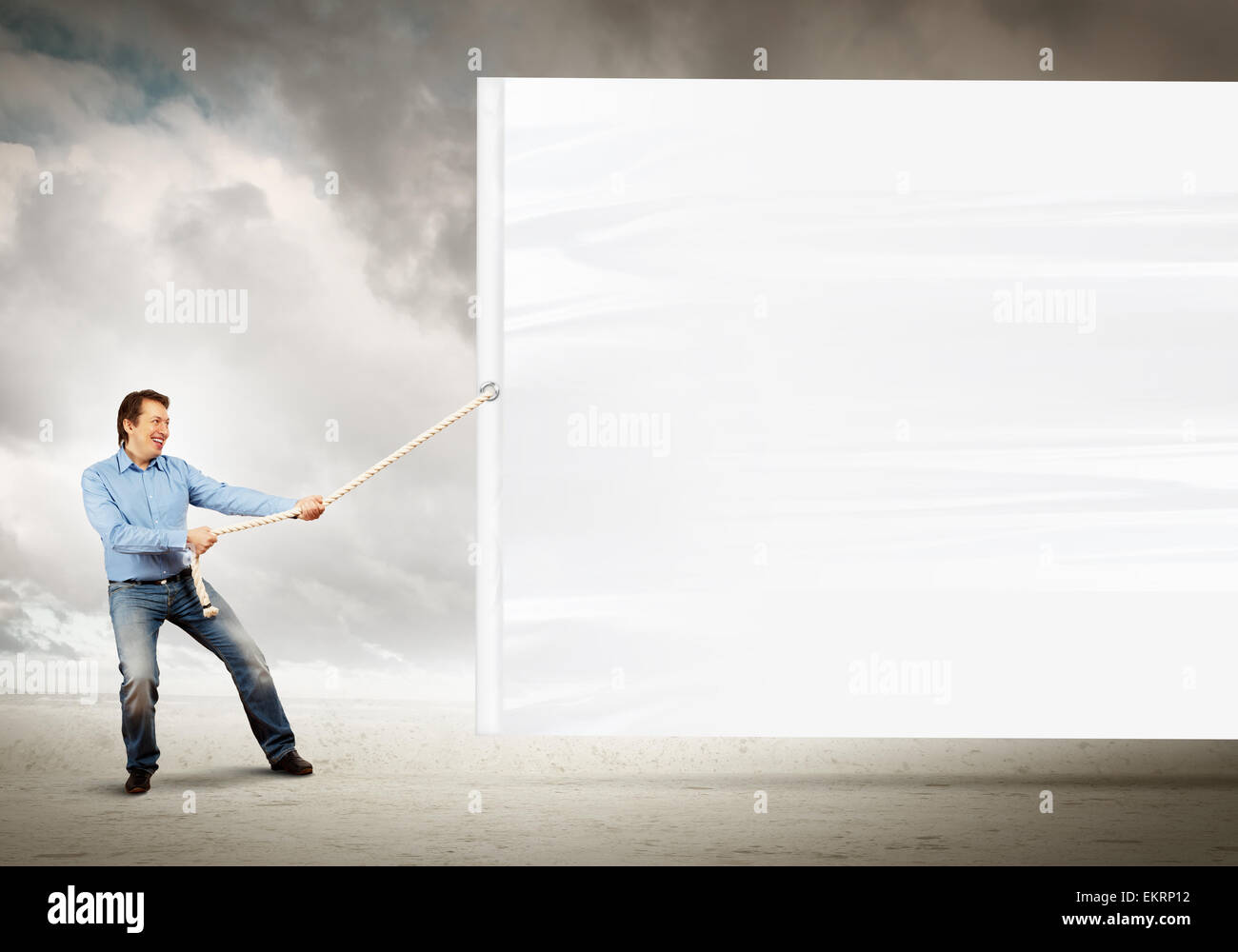 Adult man pulling blank banner Stock Photo - Alamy