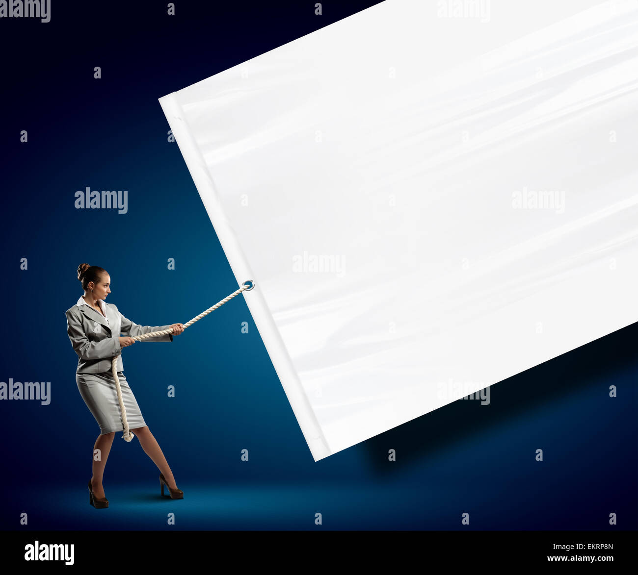 Businesswoman pulling banner Stock Photo - Alamy