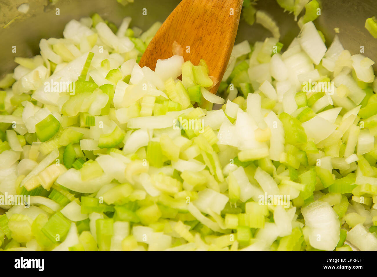Chopped celery in a pan stirring with wood spoon Stock Photo - Alamy