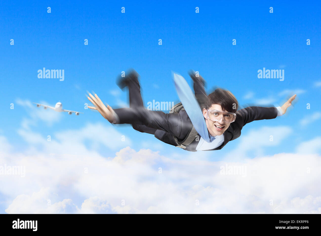 Young businessman flying with parachute on back Stock Photo - Alamy