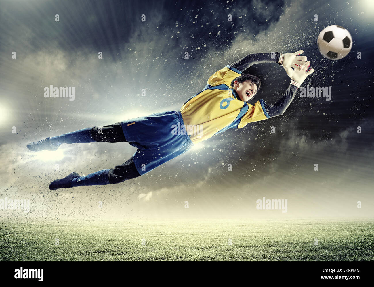 Goalkeeper catches the ball Stock Photo - Alamy