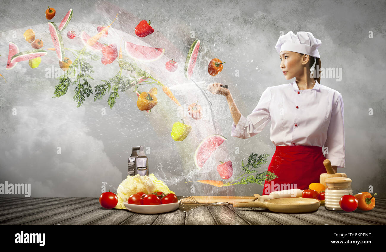Asian female cook with knife Stock Photo - Alamy