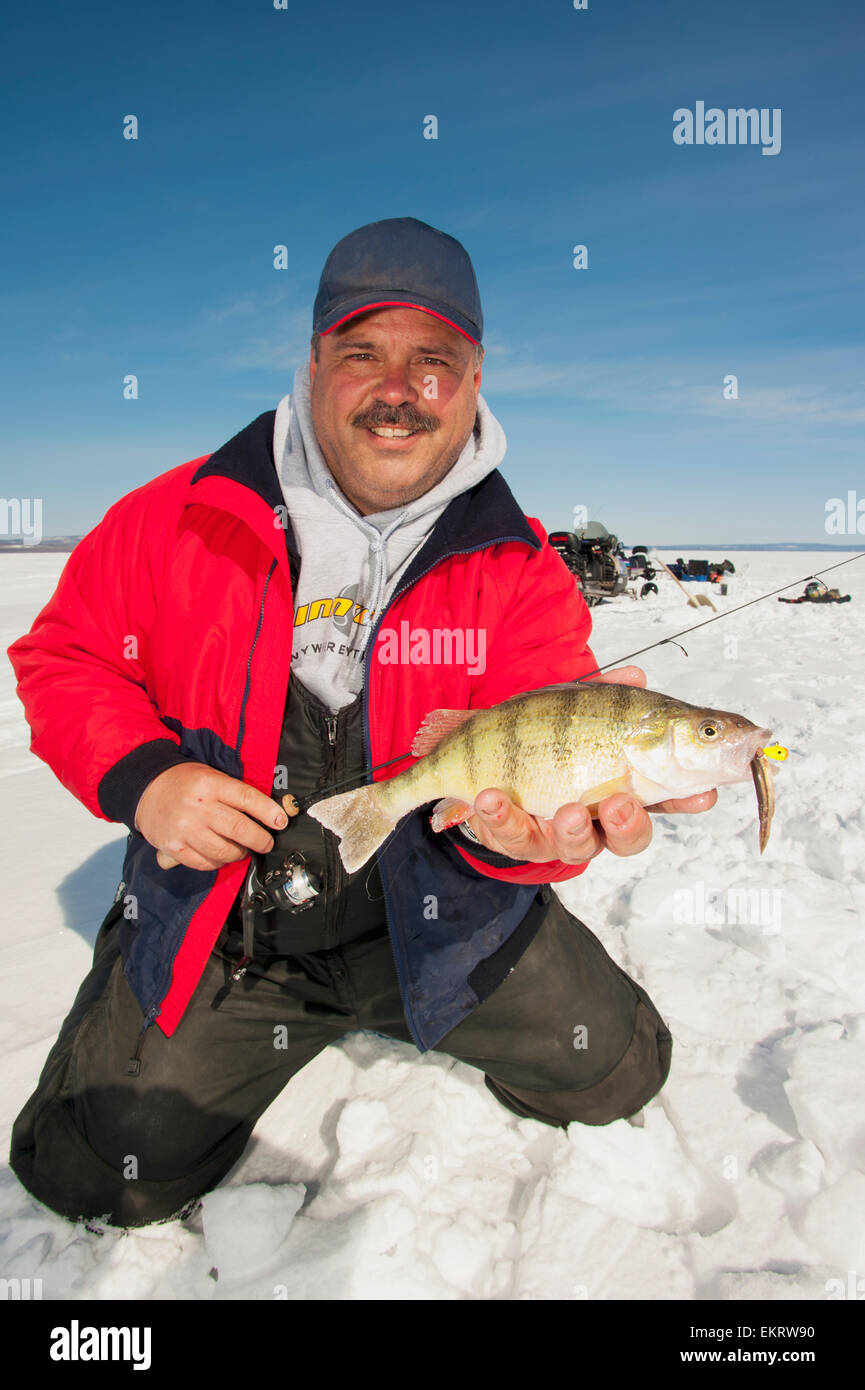 Ice fisherman holding a walleye fish; Ontario, Canada Stock Photo - Alamy