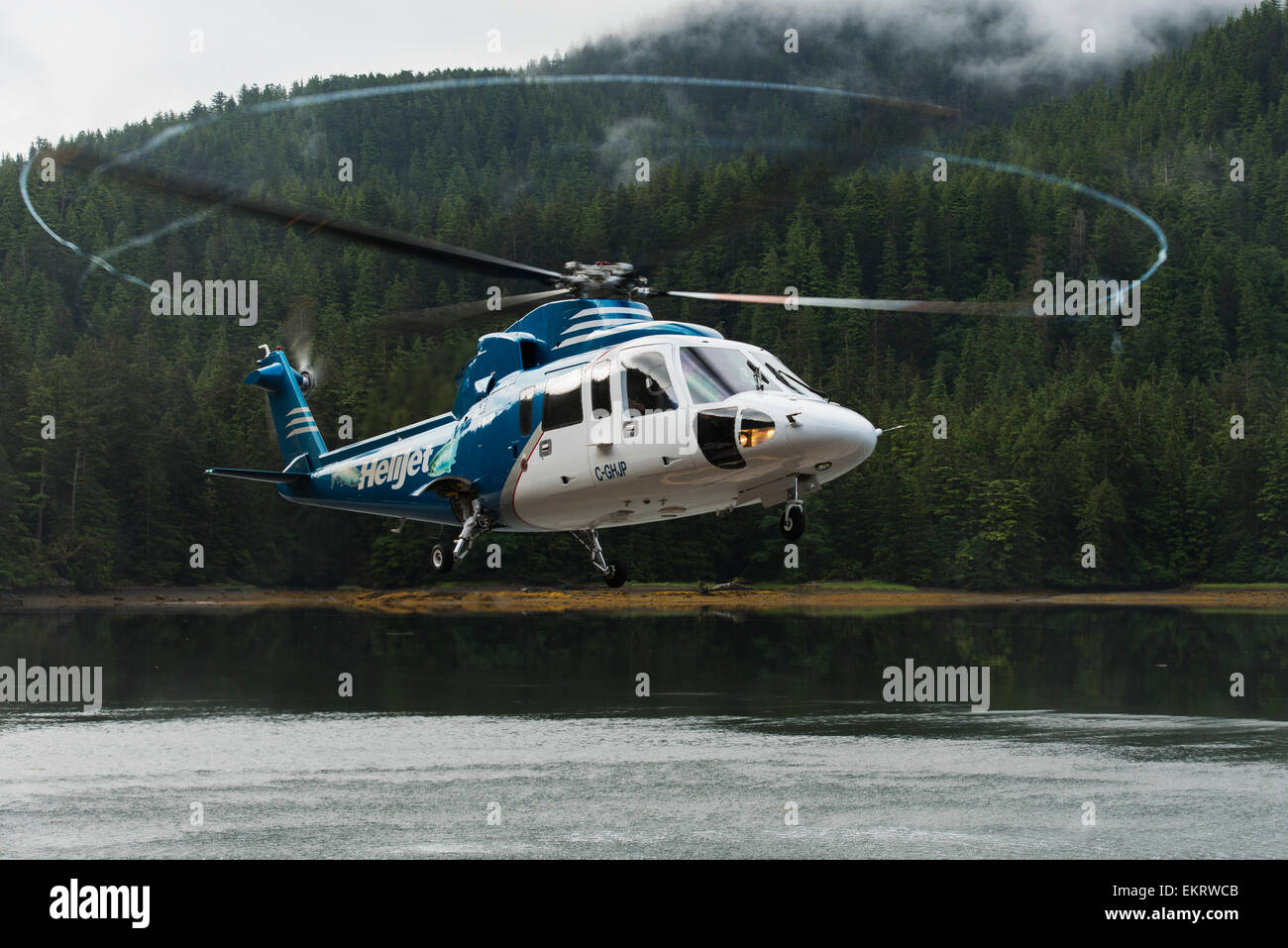 Helicopter hovering over water while taking off; Queen Charlotte ...