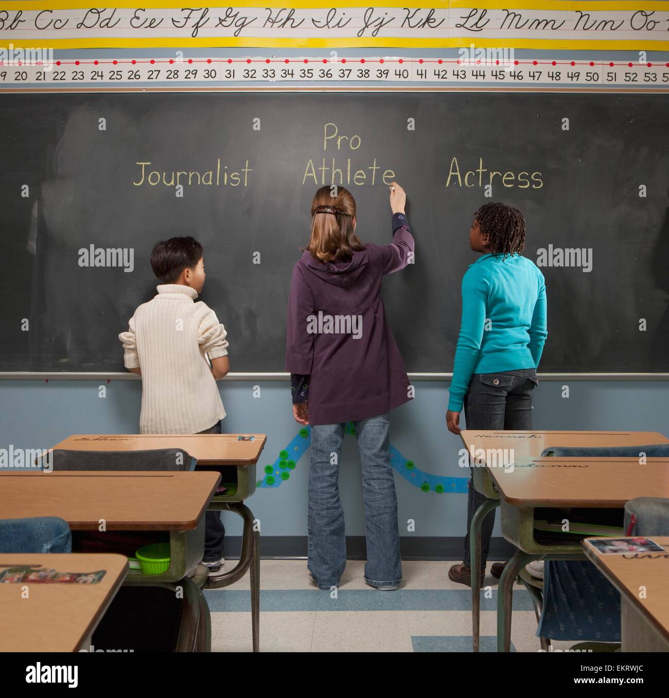 Children Writing Their Future Careers On Blackboard Stock Photo - Alamy