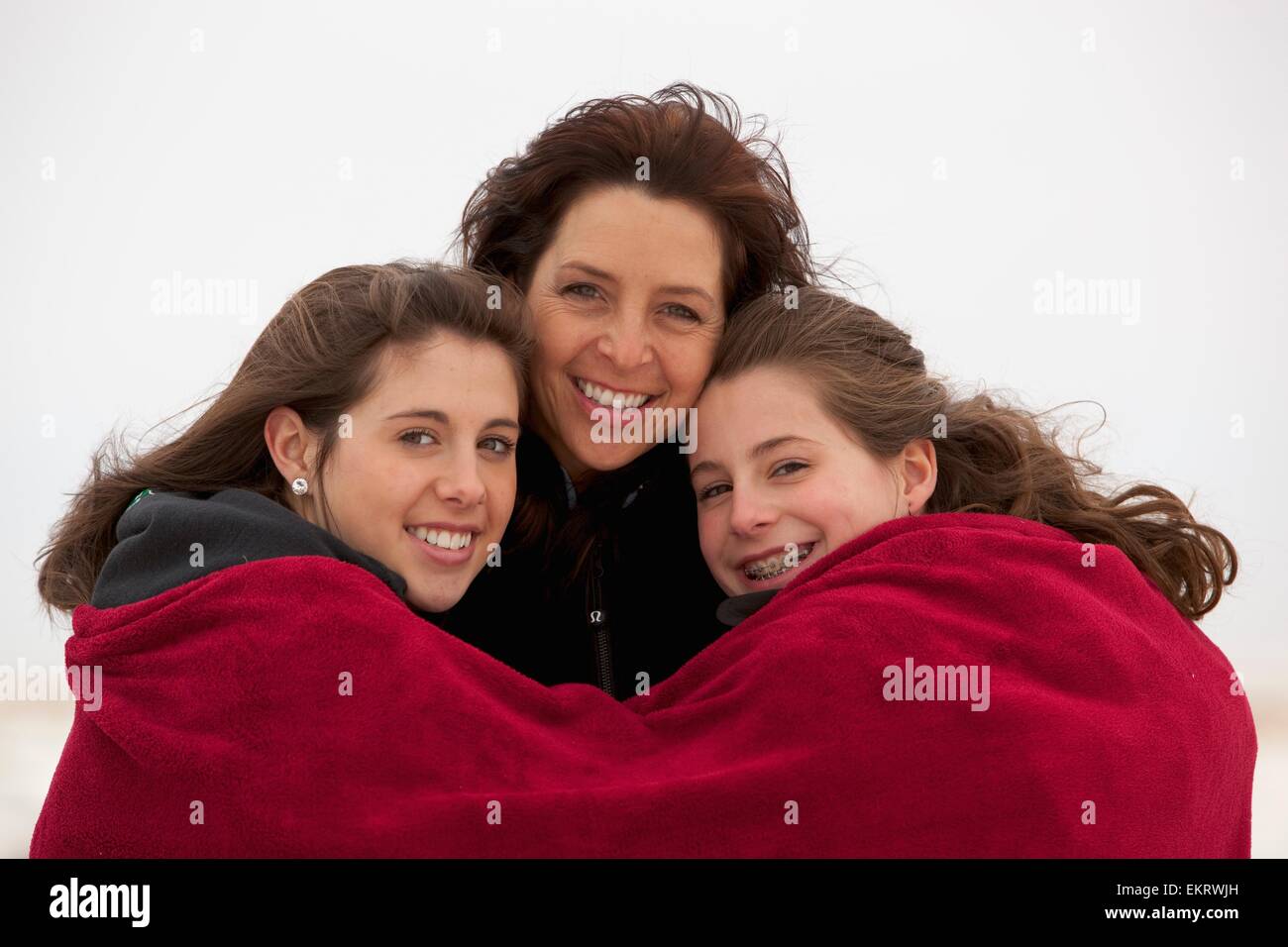 Mother And Daughters Huddle Together Outdoors Under Blanket Stock Photo ...