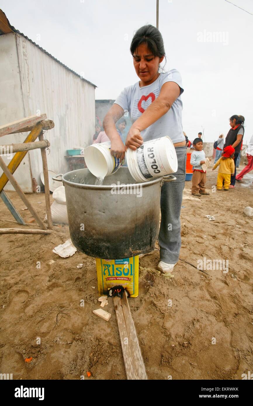 Woman Pouring Water Into Pot, Lima, Peru Stock Photo - Alamy