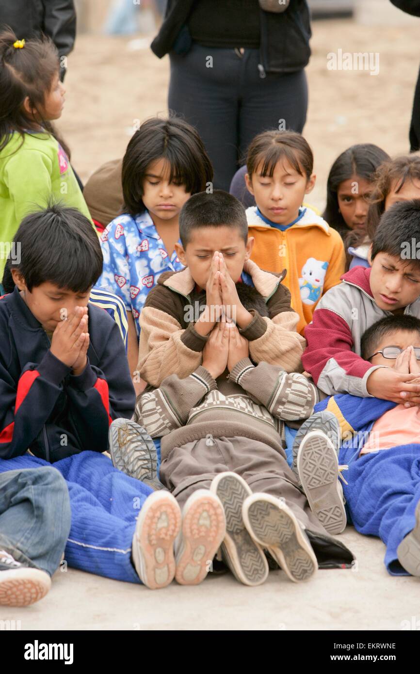 Young Children Praying, Lima, Peru Stock Photo - Alamy