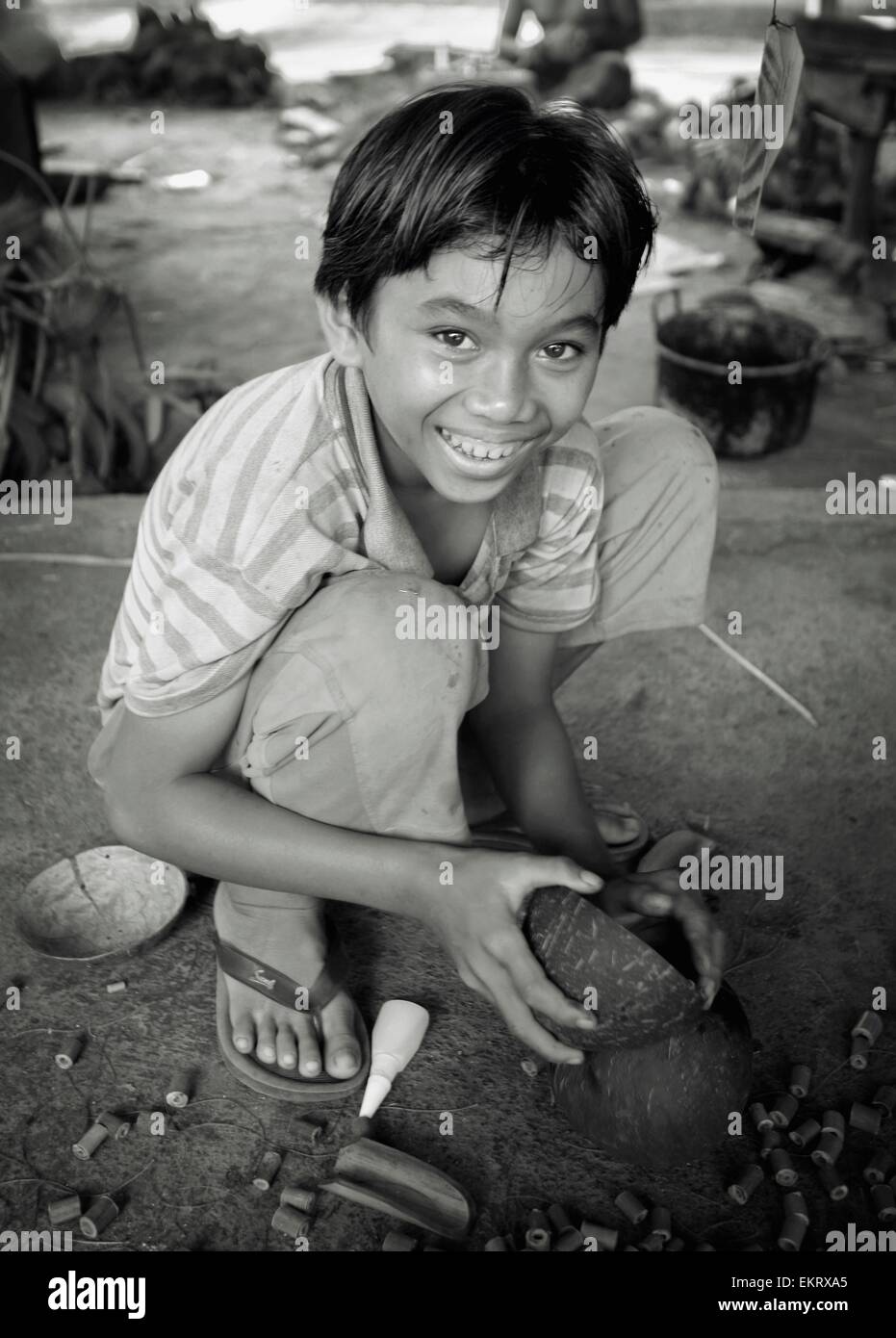 Young Boy Crouching And Smiling Stock Photo - Alamy