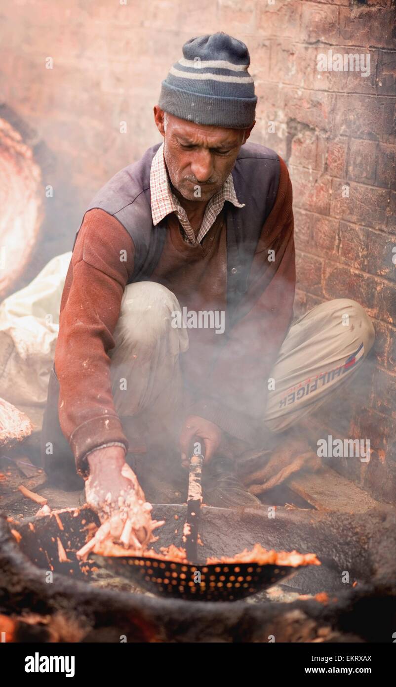 Man Cooking Over A Fire; Dal Lake, Srinagar, Kashmir, India Stock Photo ...