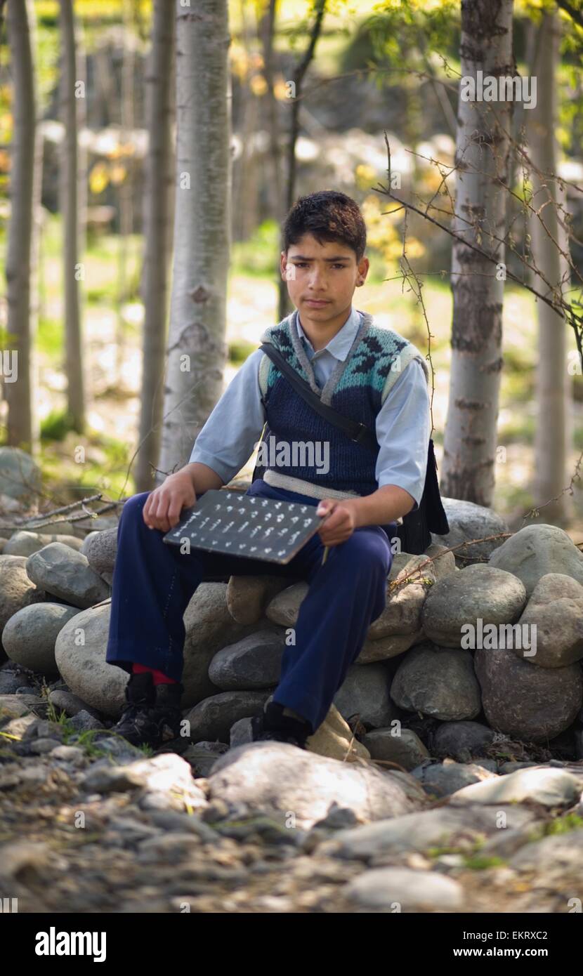 Boy Sitting On Rocks Stock Photo - Alamy