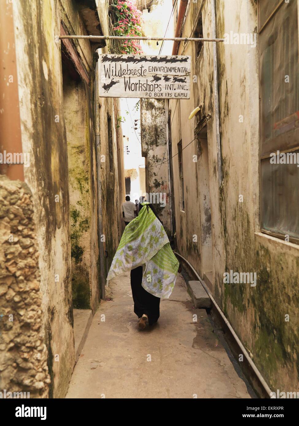 Woman Between Two Buildings; Kenya, Africa Stock Photo - Alamy