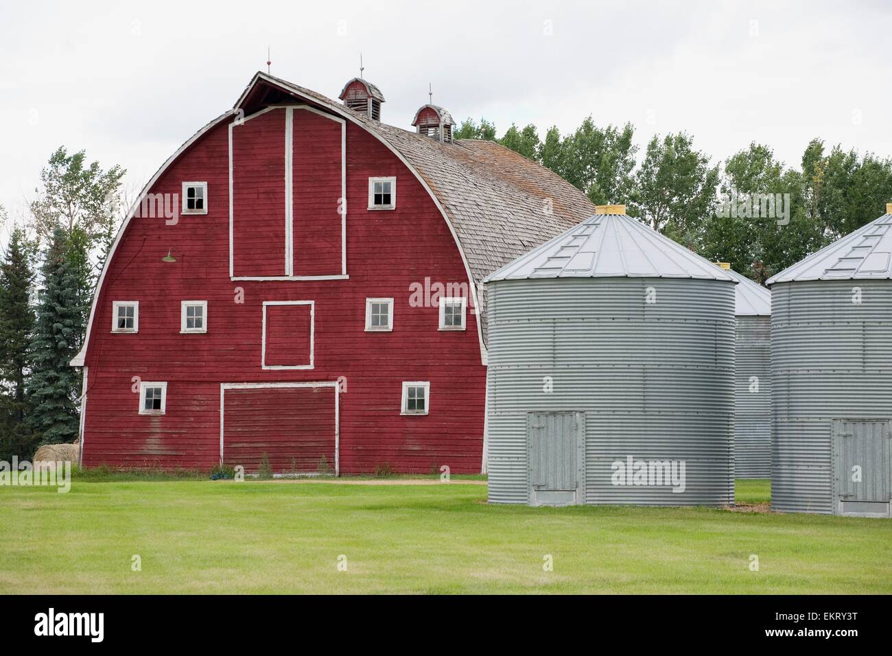 Alberta, Canada; Red Barn And Metal Grain Bins Stock Photo - Alamy